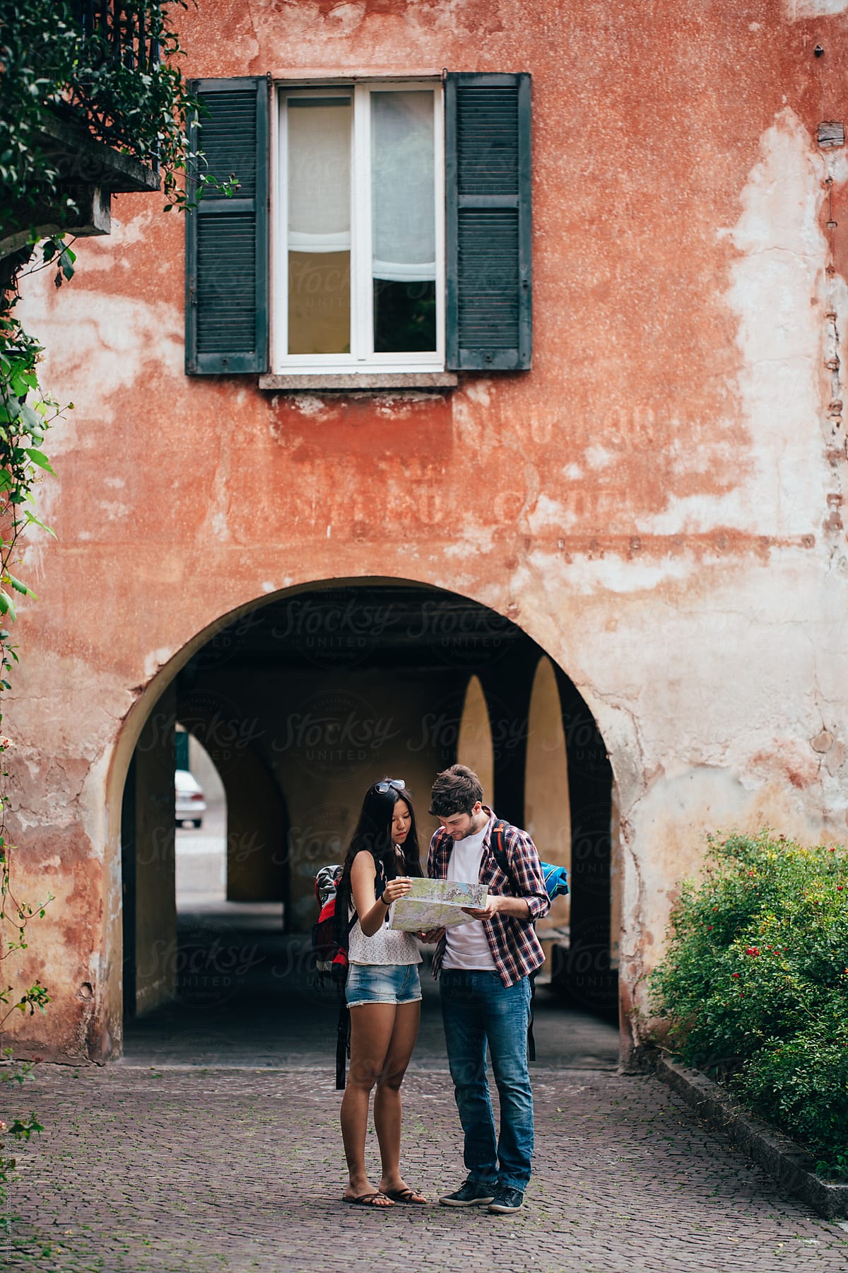 "Backpackers Looking At The Map" by Stocksy Contributor "Michela ...