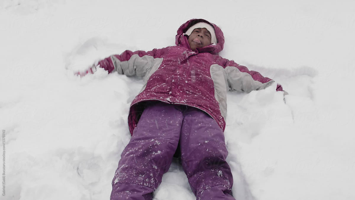 "African American Girl Making Snow Angels In Fresh Snow" by Stocksy ...