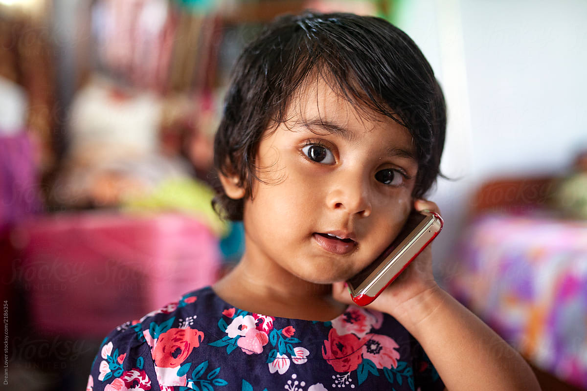 "Cute Baby Speaking In Smartphone Inside Room" by Stocksy Contributor ...