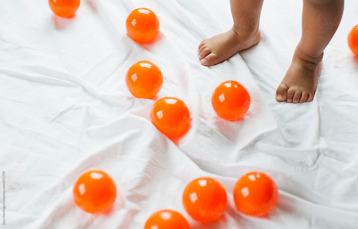 "Baby Feet And Orange Balls" by Stocksy Contributor "Sara Remington ...