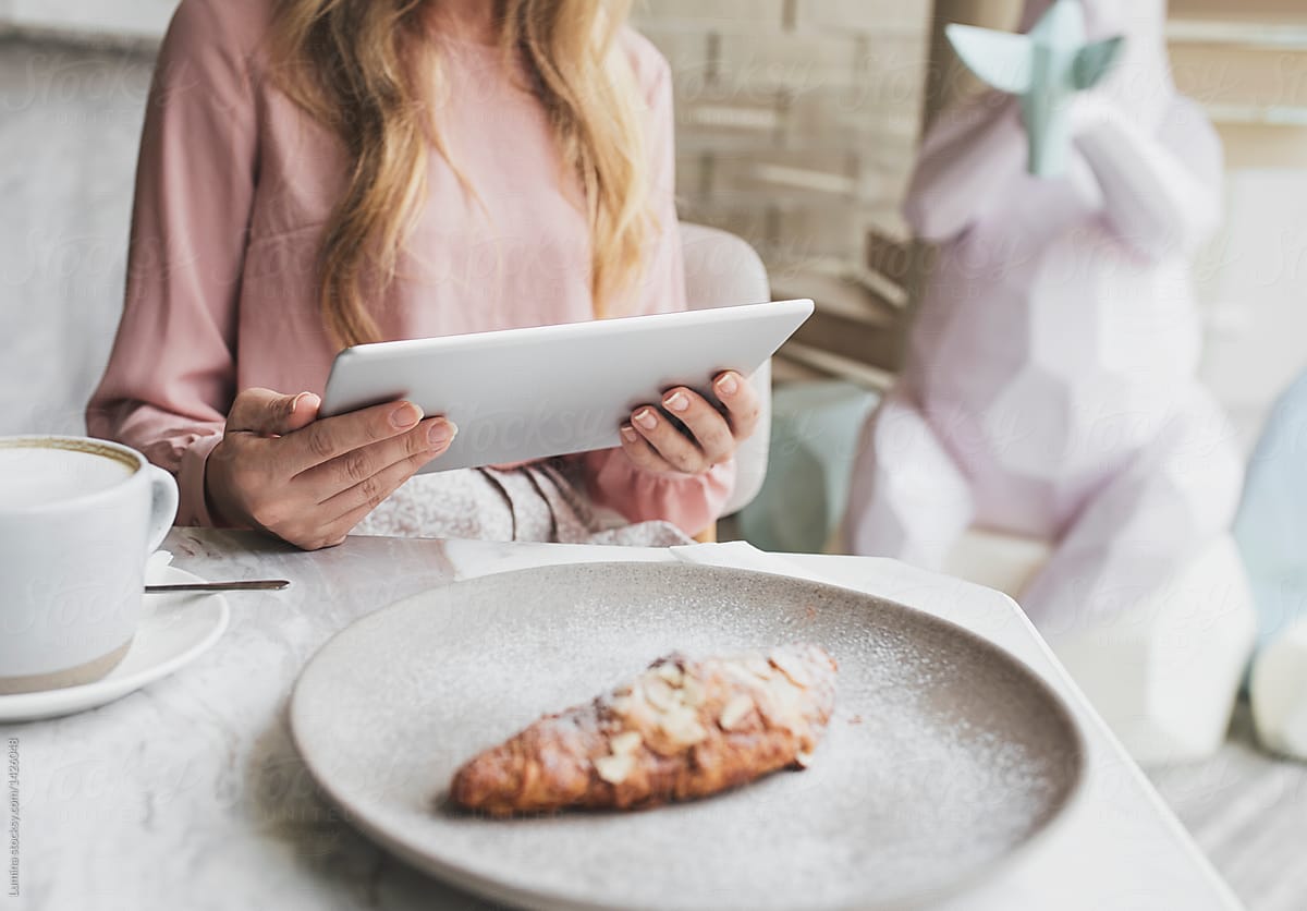 "Woman Reading On Tablet" by Stocksy Contributor "Lumina" - Stocksy