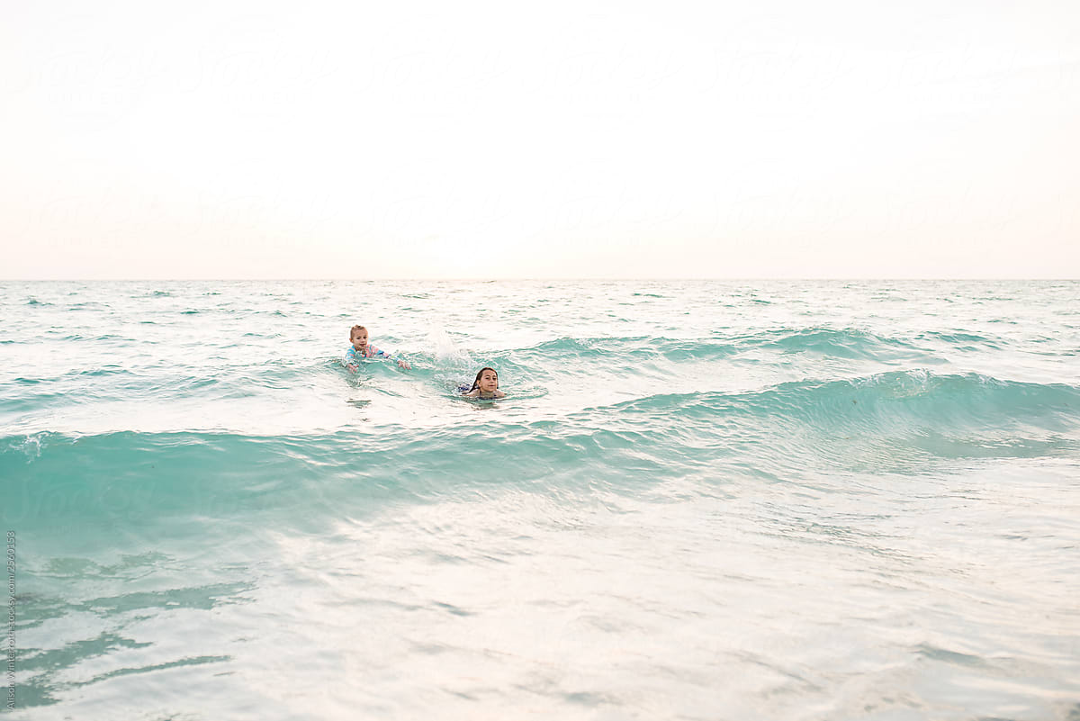 "Children Swimming To Shore" by Stocksy Contributor "Alison Winterroth ...