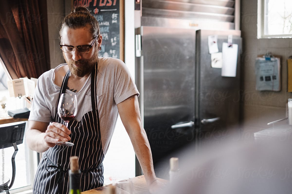 "Hip Bar Owner Tending His Bar" by Stocksy Contributor "Kristine ...