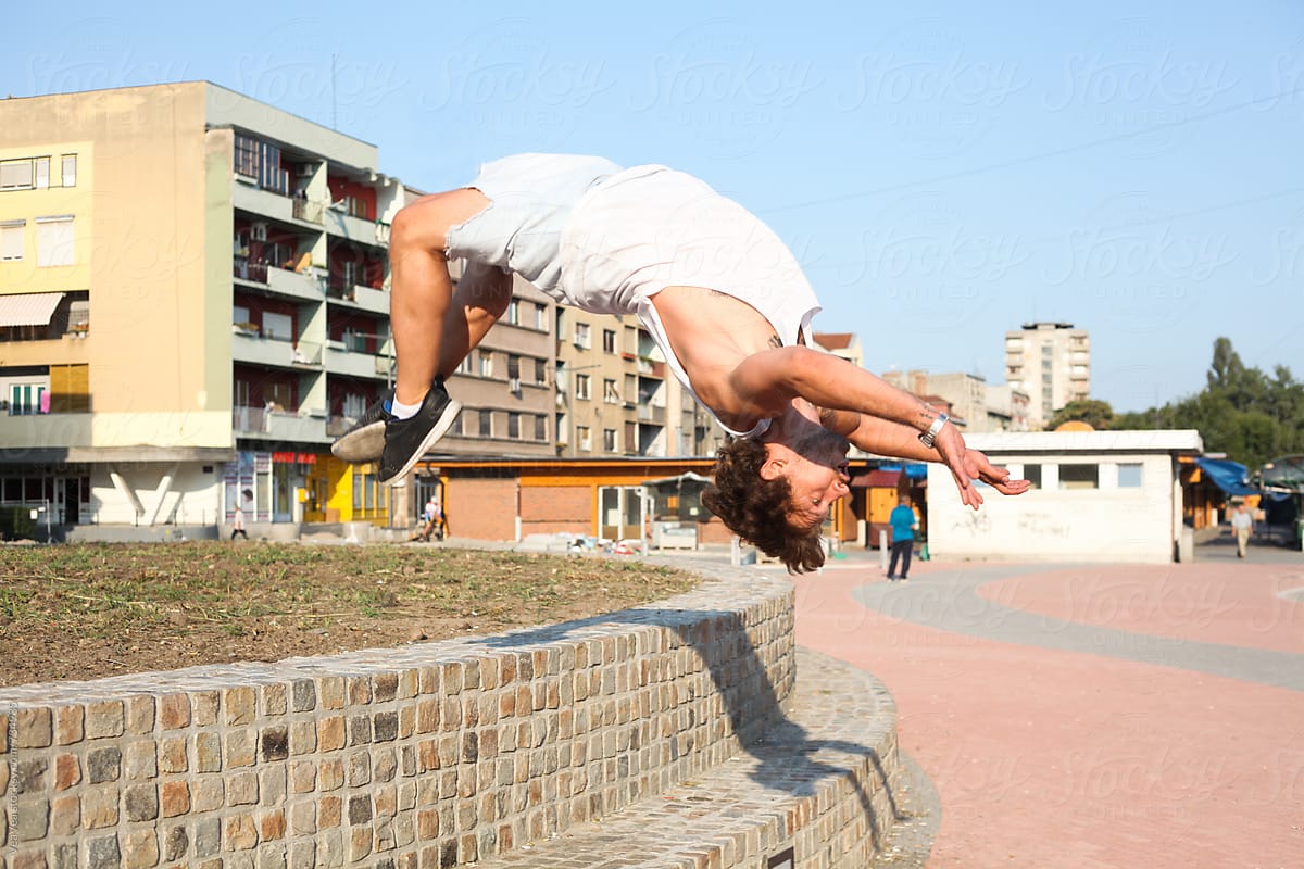 "Man Jumping In The City" by Stocksy Contributor "Marija Mandic" - Stocksy