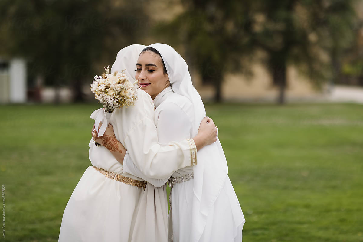 Emotional bride being congratulated by her friends - Stock Image ...