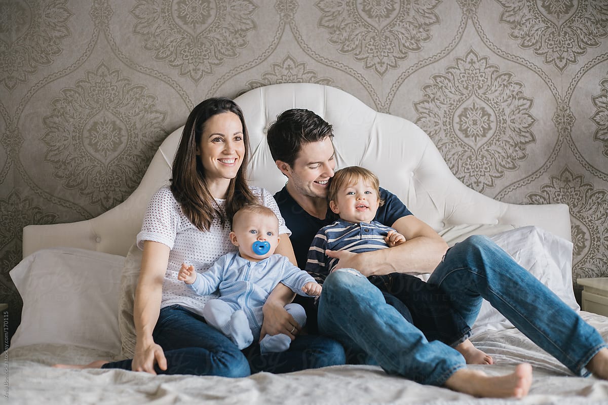 "Family Portrait Sitting In Bed, Parents And Two Sons" by Stocksy ...