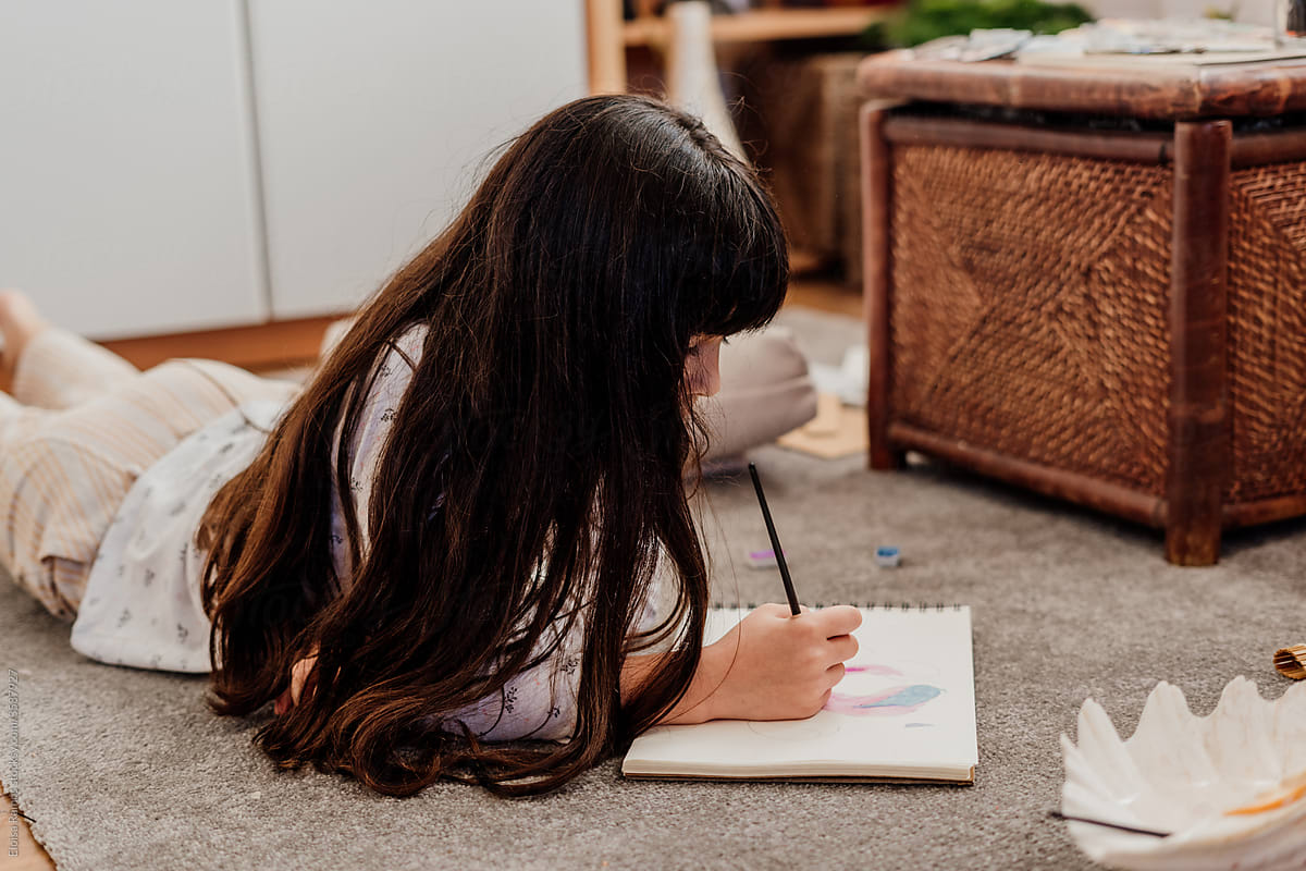 "Little Girl Drawing Lying On The Floor At Room" by Stocksy Contributor ...