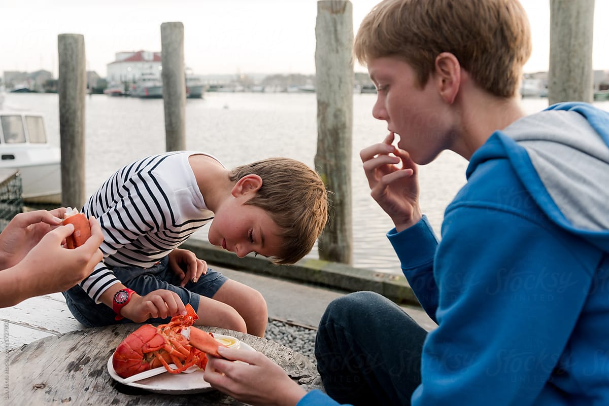 "Two Brothers Eating Lobster At A Seaport" by Stocksy Contributor "Lea ...