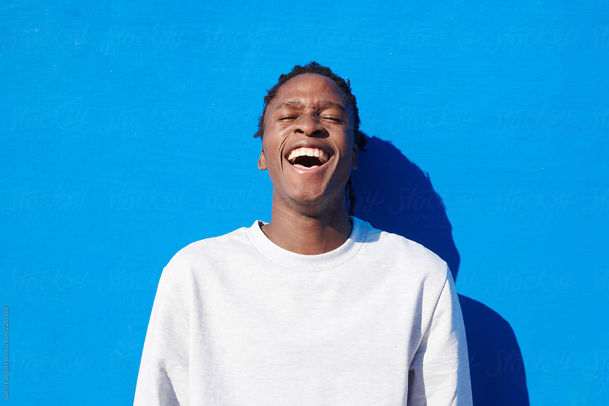 "Laughing Bright Black Man Outdoors" by Stocksy Contributor "Guille ...
