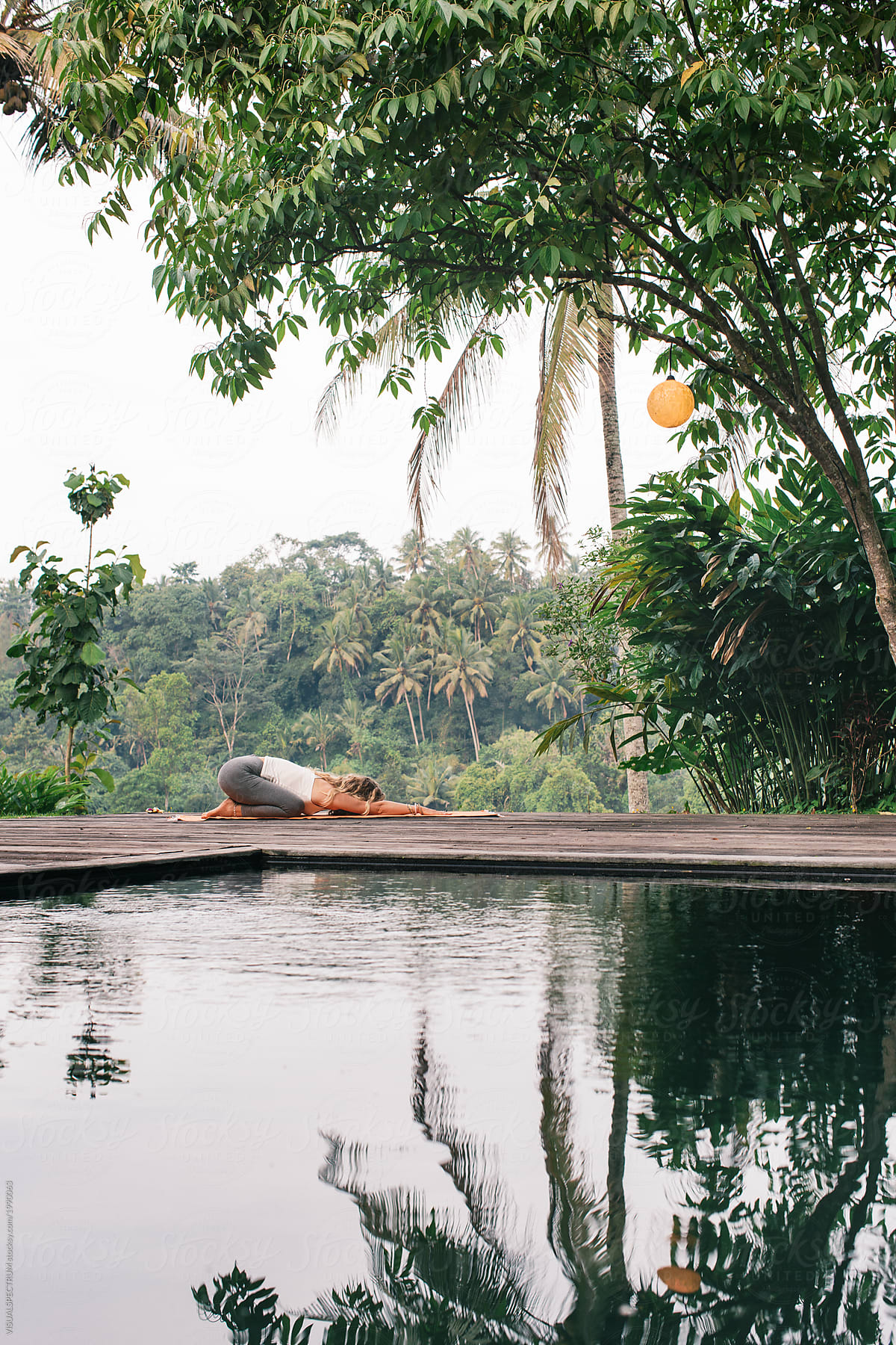 "Female Yoga Practitioner Stretching By Pool In Tropics" by Stocksy ...