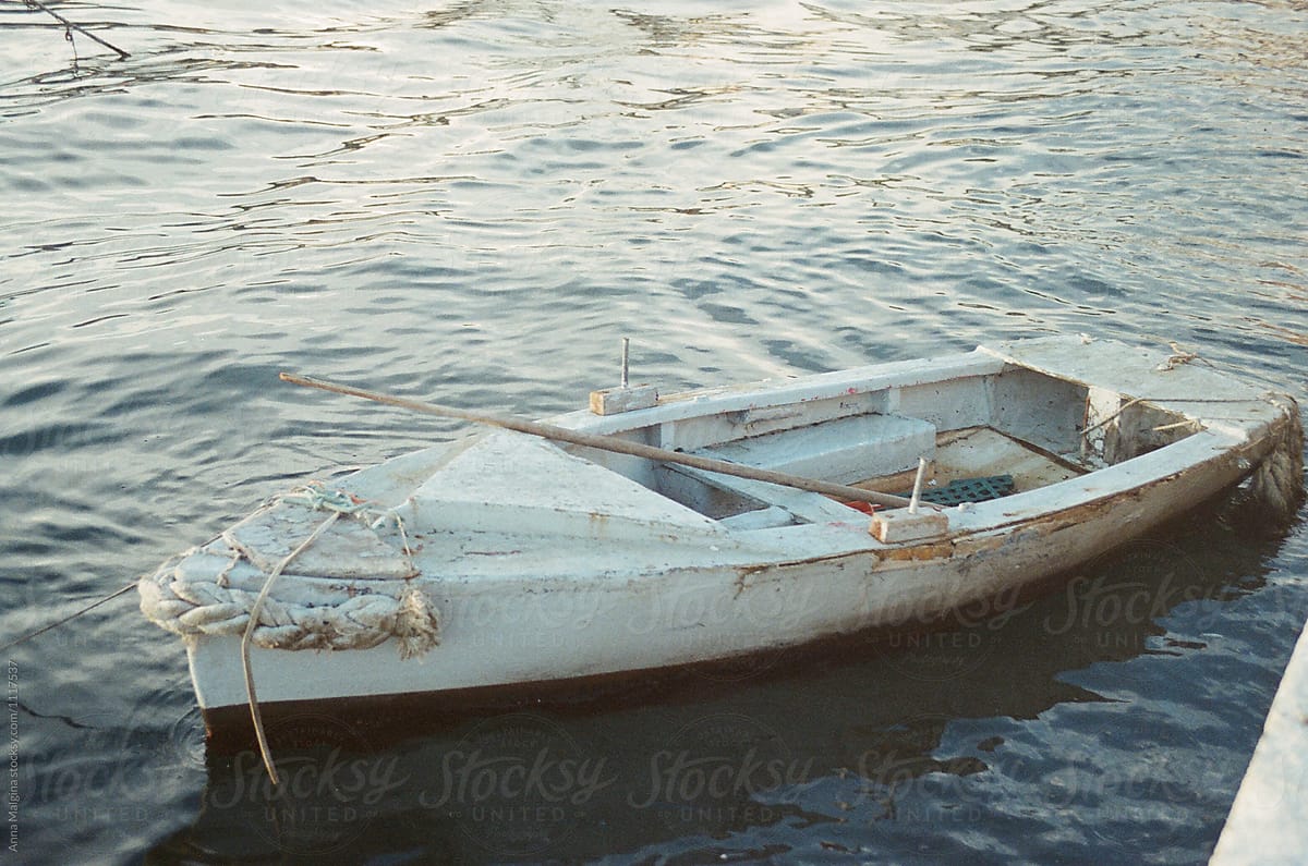 "An Old Boat In The Water" by Stocksy Contributor "Anna Malgina" - Stocksy