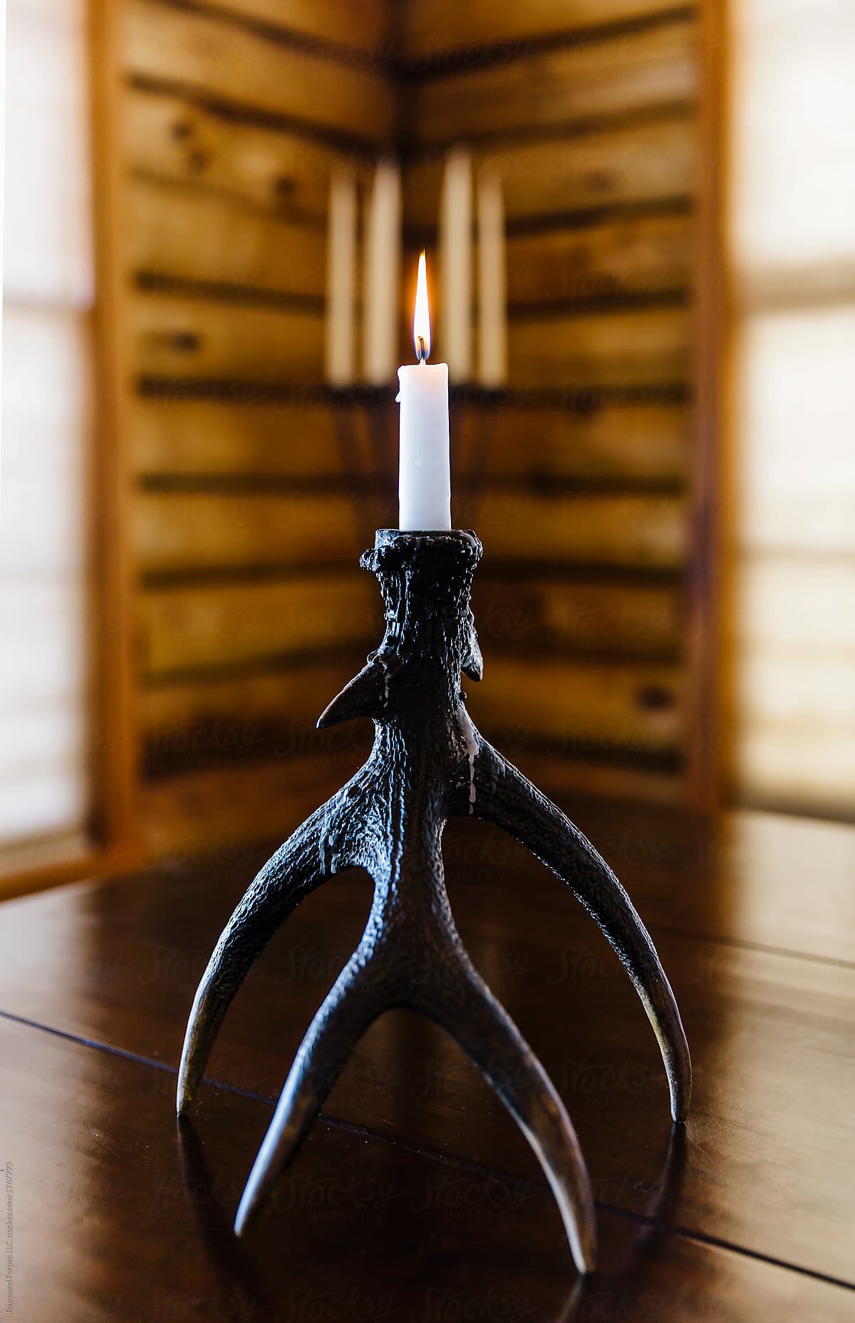 "Deer Antler Candlestick In Log Cabin" by Stocksy Contributor "Raymond ...
