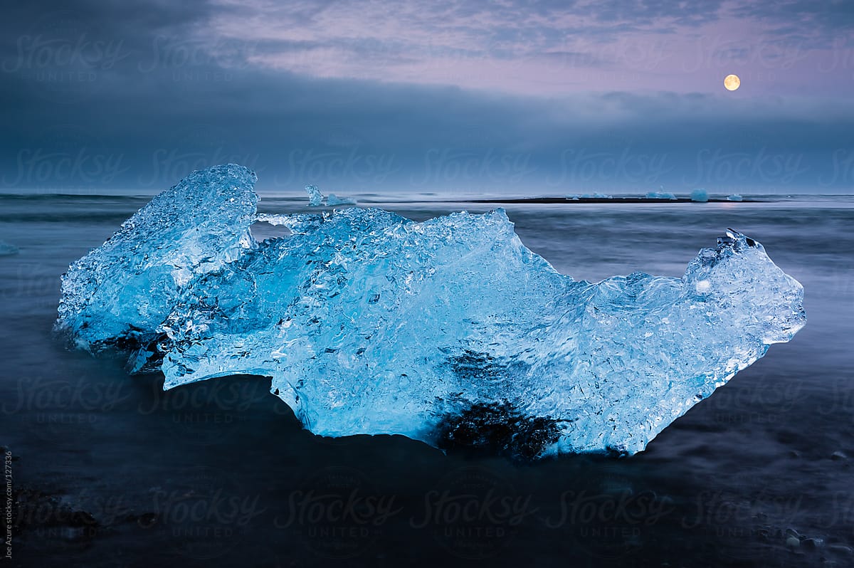 "Full Moon Over Black Sand And Ice" by Stocksy Contributor "Joe Azure ...
