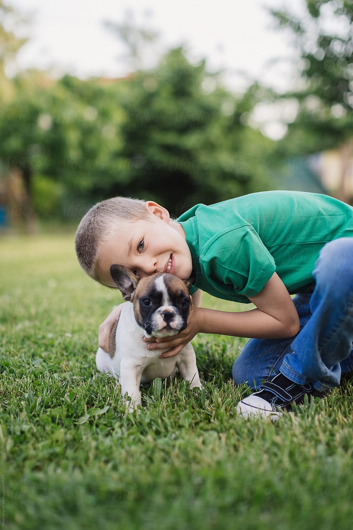 "Young Boy Playing With Dog" by Stocksy Contributor "Mauro Grigollo ...