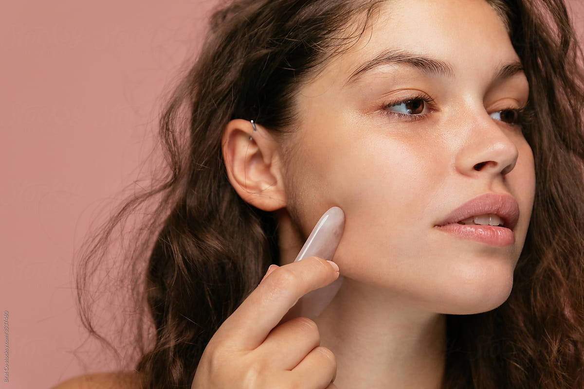 "Woman Using Gua Sha Stone" by Stocksy Contributor "Brat Co" - Stocksy