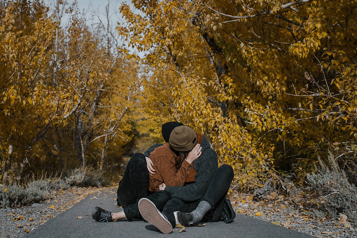 "Two Girls Hugging And Cuddling Close Together On The Floor Outdoors In ...