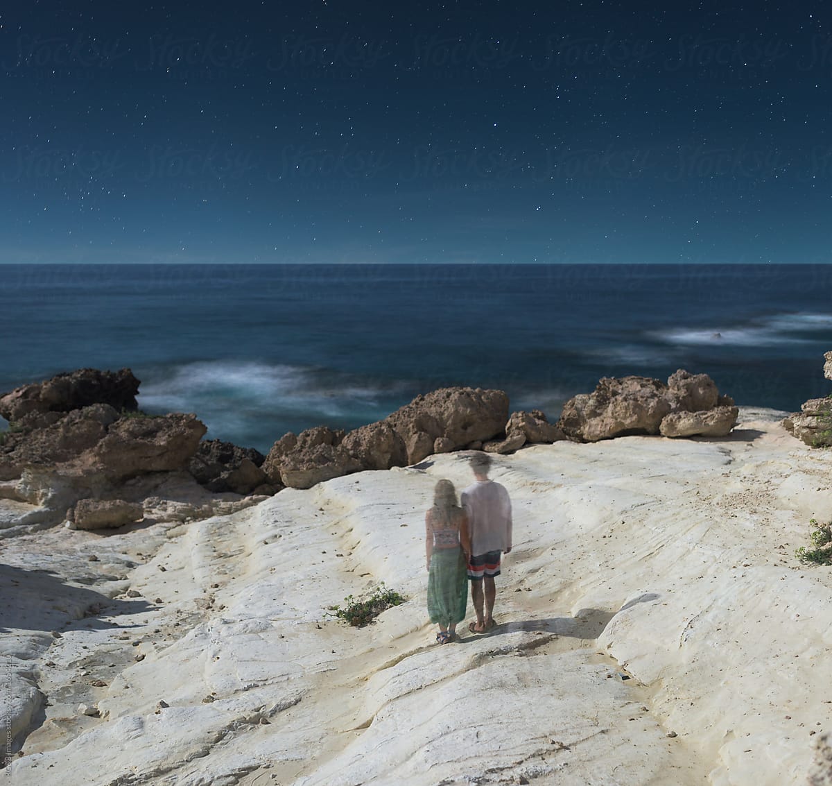 "Romantic Couple Admiring The Breathtaking View Of The Sea At Night" by ...
