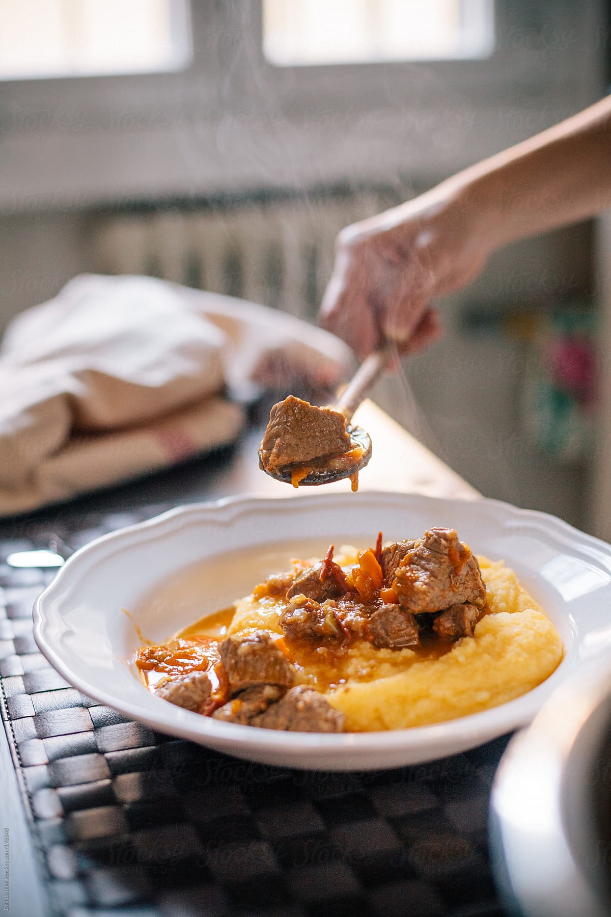 "Serving Beef Stew With Polenta" by Stocksy Contributor "Davide Illini ...