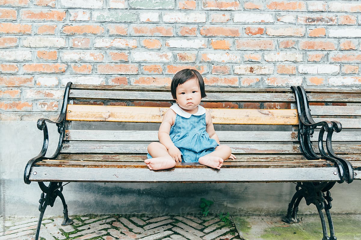 "Baby Girl Sitting On A Bench" by Stocksy Contributor "Pansfun Images ...