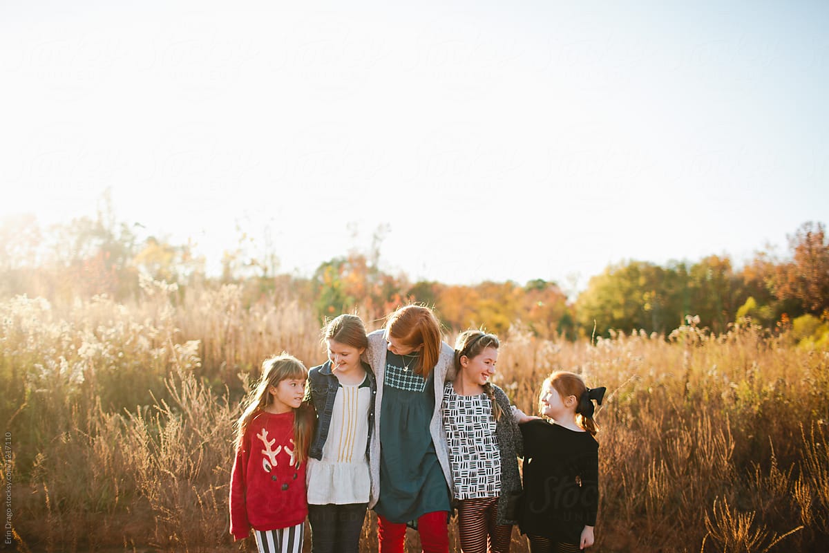 "Friends In A Field" by Stocksy Contributor "Erin Drago" - Stocksy