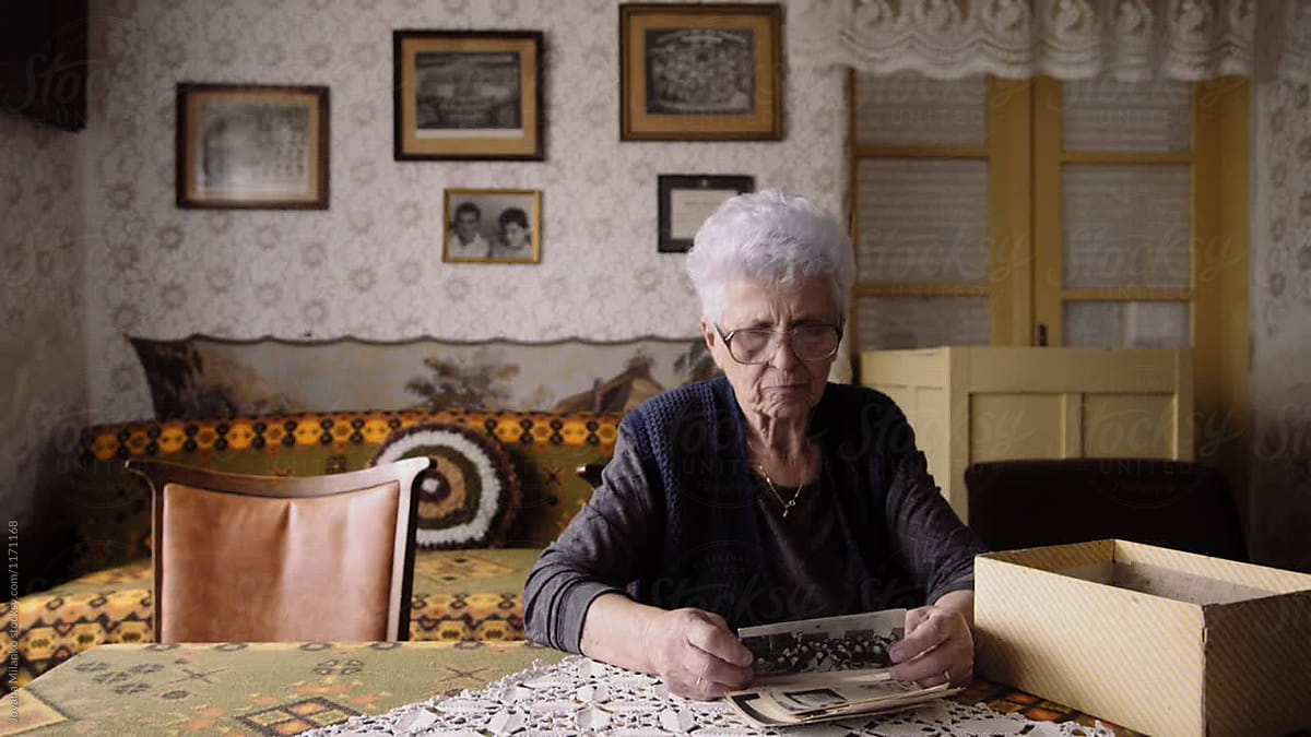 "Senior Woman Sitting Alone In Her Living Room, Looking At The Old ...
