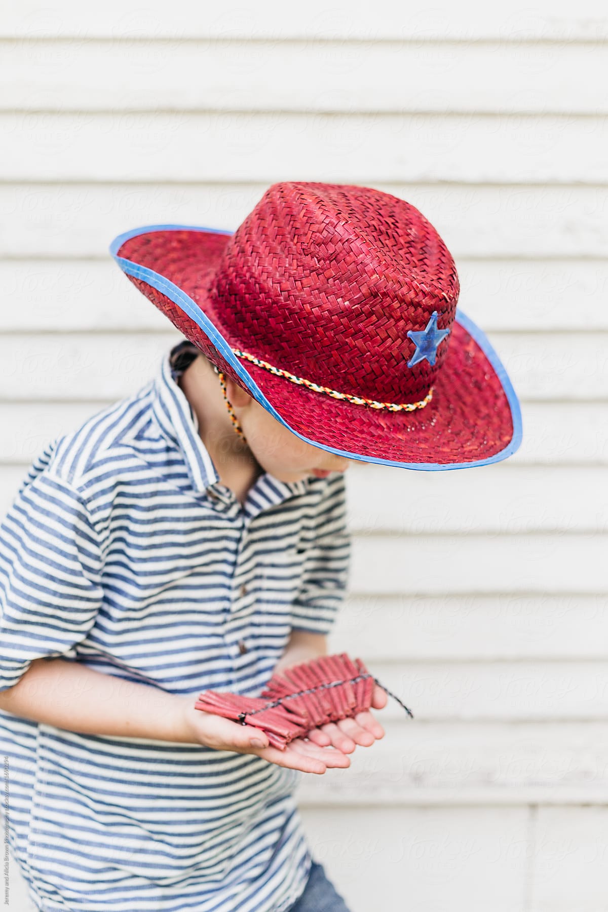 "Little Cowboy Holding Firecrackers" by Stocksy Contributor "ALICIA ...