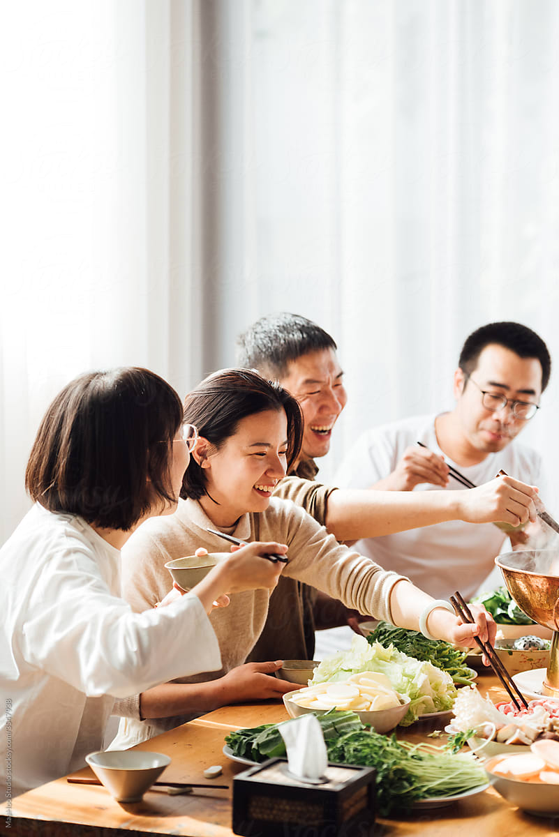 "Eating Chinese Hot Pot" by Stocksy Contributor "MaaHoo" - Stocksy