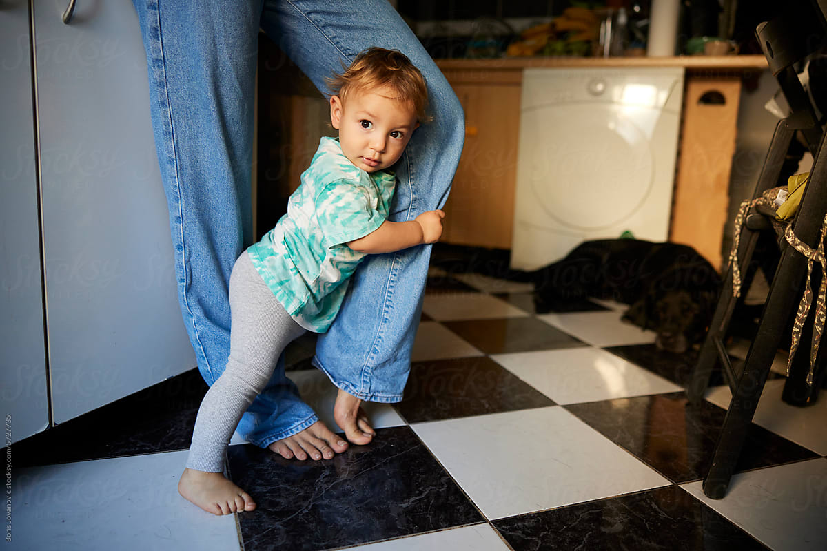 "Little Boy Holds His Mother's Leg" by Stocksy Contributor "Boris ...