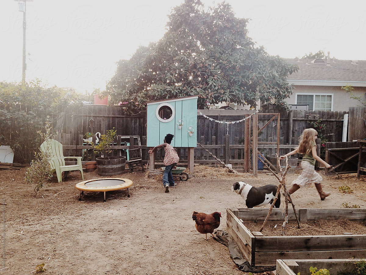 "Two Girls Running Around Back Yard" by Stocksy Contributor "Kristin ...