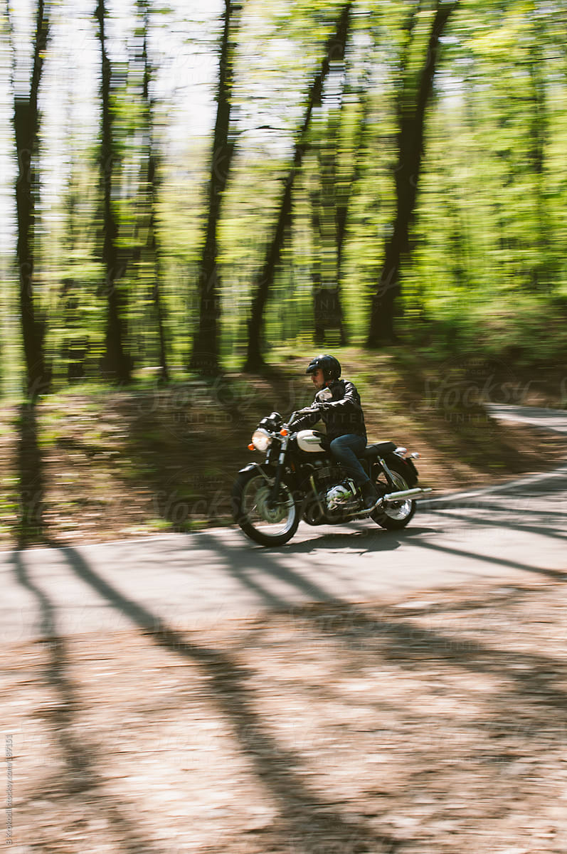 "Man Riding Motorcycle Through The Forest" by Stocksy Contributor "B ...