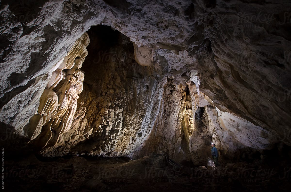 "Cave Scene With Explorer Looking At Limestone Formations" by Stocksy ...