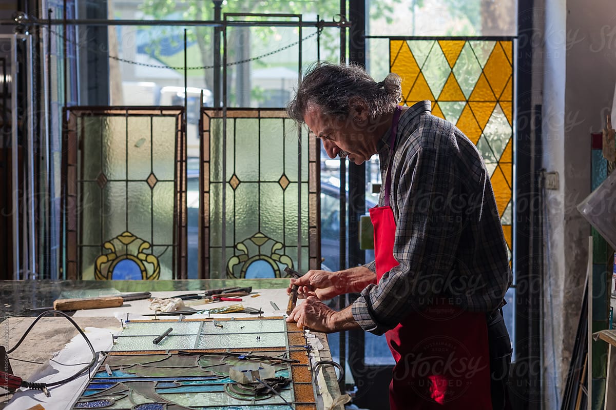 "Artisan Working On Stained Glass In His Workshop" by Stocksy ...