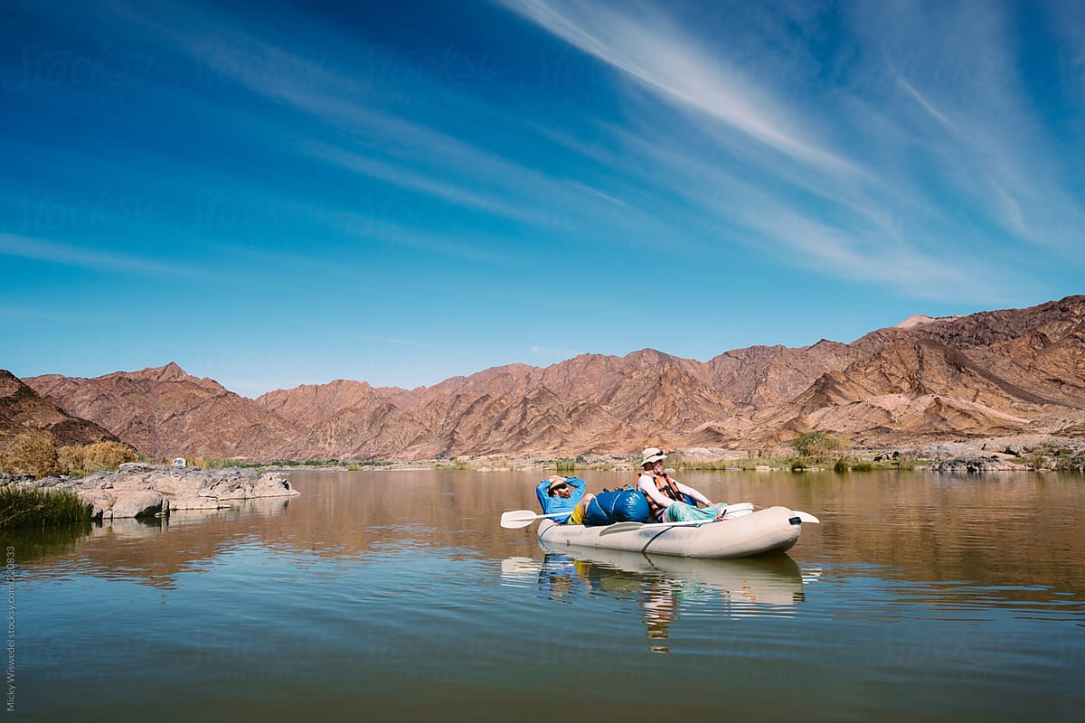 "Friends Relaxing On An Inflatable Canoe On The Orange River" by ...