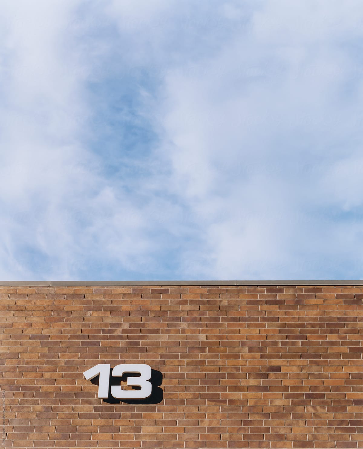 "Number 13 On Brick Wall, Sky And Clouds Above" by Stocksy Contributor ...