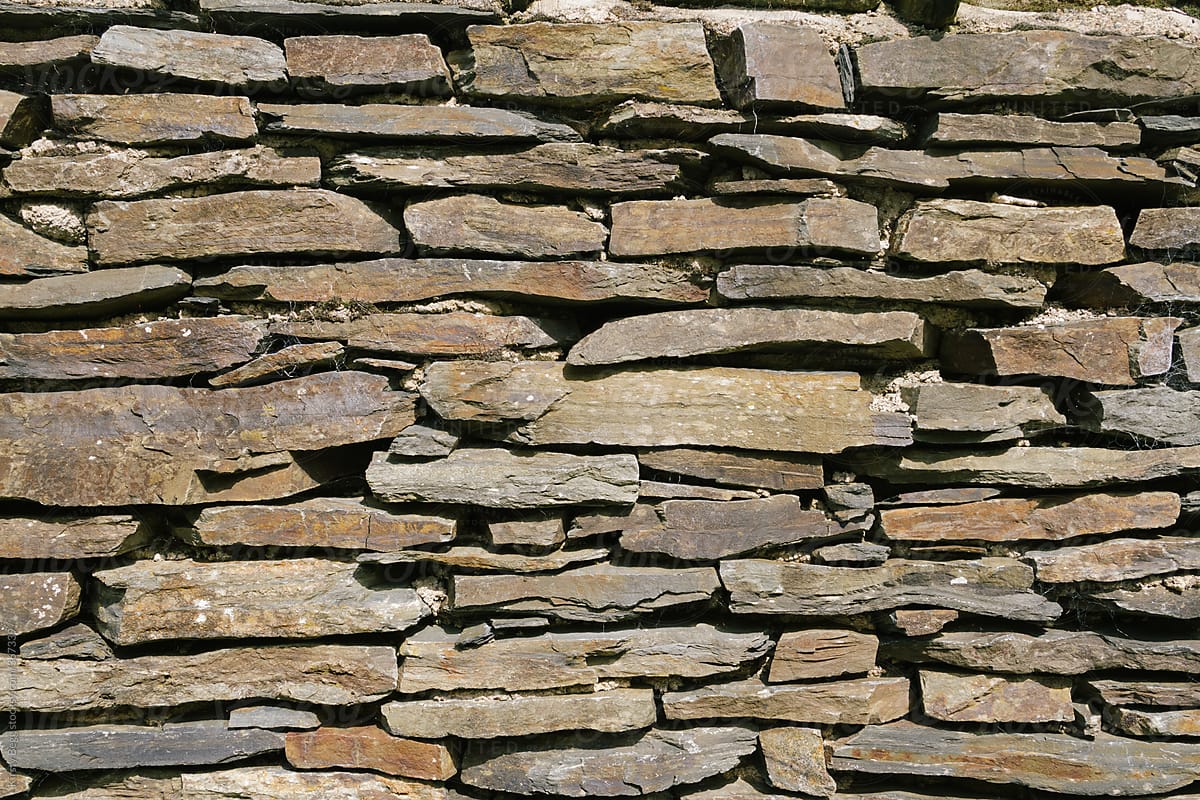 "Drystone Slate Wall" by Stocksy Contributor "Kirsty Begg" - Stocksy