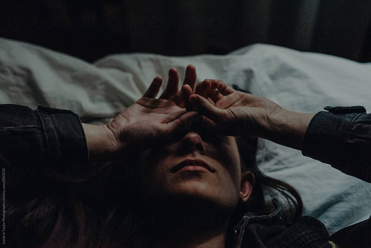 "Woman Laying On A Bed Covering Face With Her Hands" by Stocksy ...