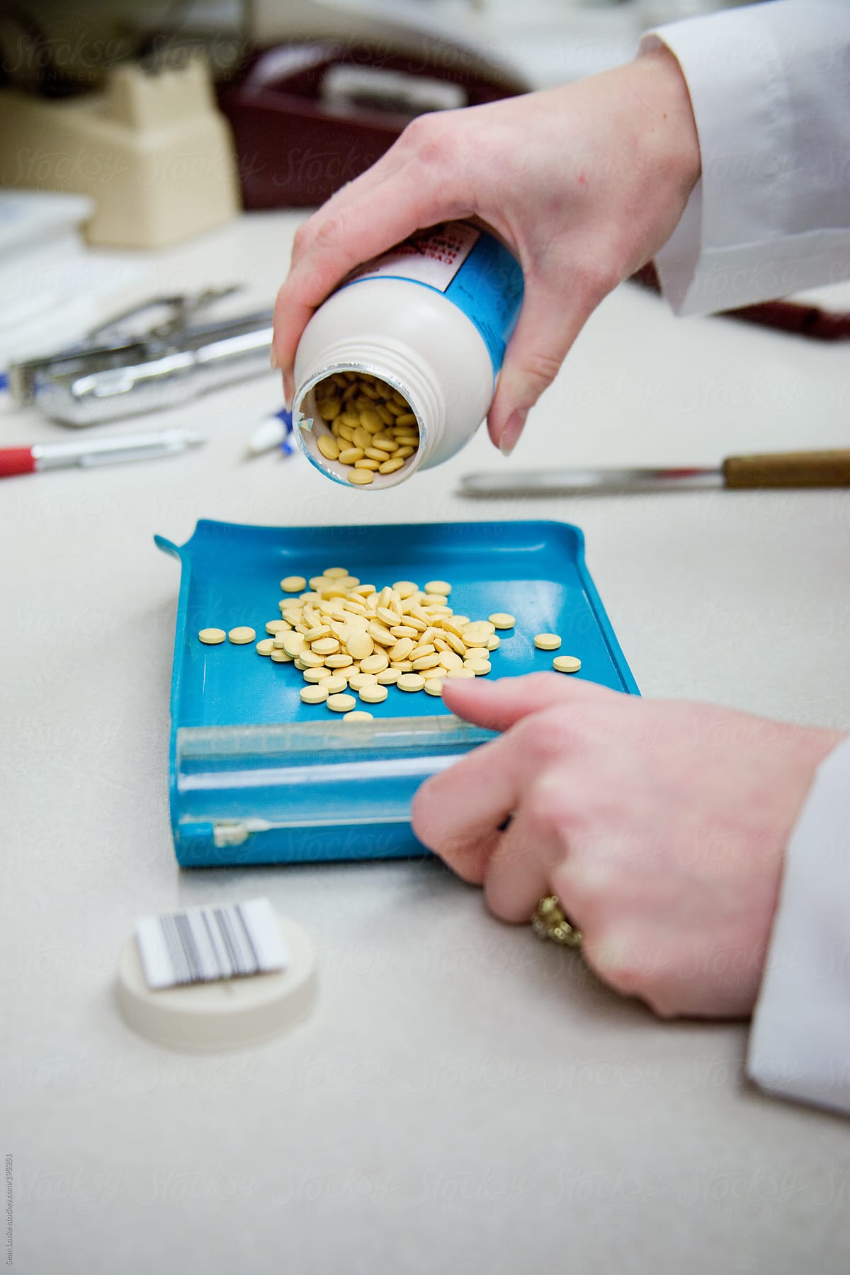 "Pharmacy: Starting To Count Out Pills" by Stocksy Contributor "Sean ...