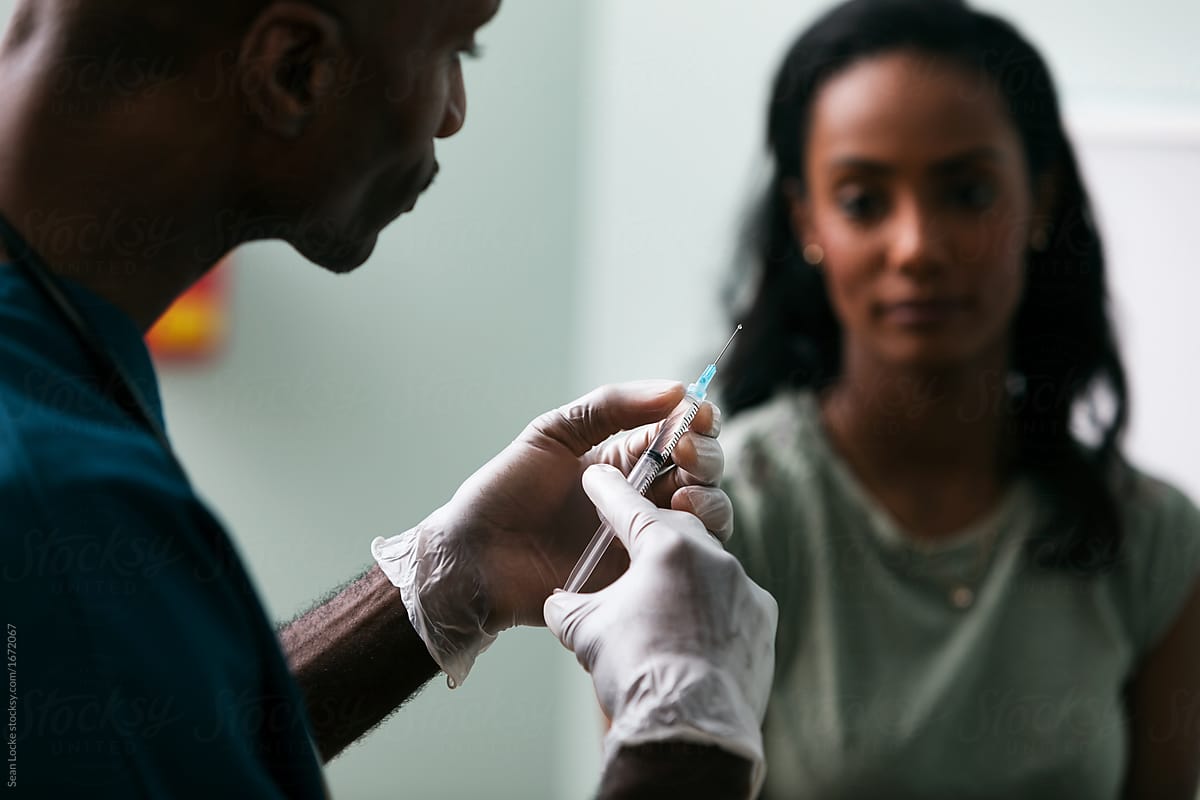 "Exam: Doctor Holding Syringe For Vaccine Shot" by Stocksy Contributor ...
