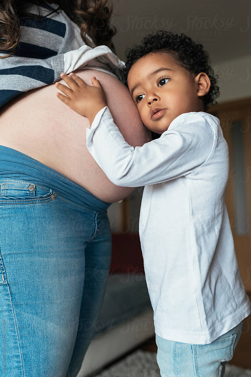 "Beautiful Mixed Race Girl Listening Pregnant Mother's Belly." by ...