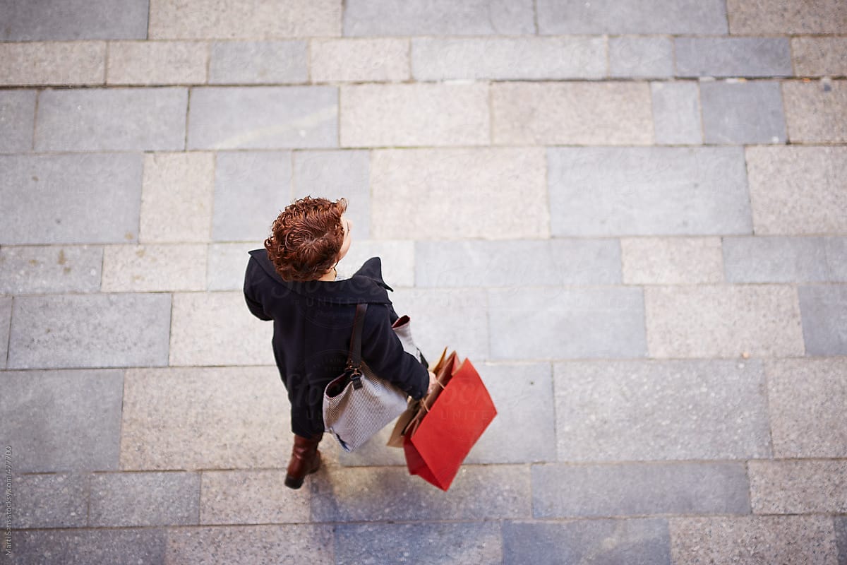 "Person With Shopping Bags" by Stocksy Contributor "Martí Sans" - Stocksy