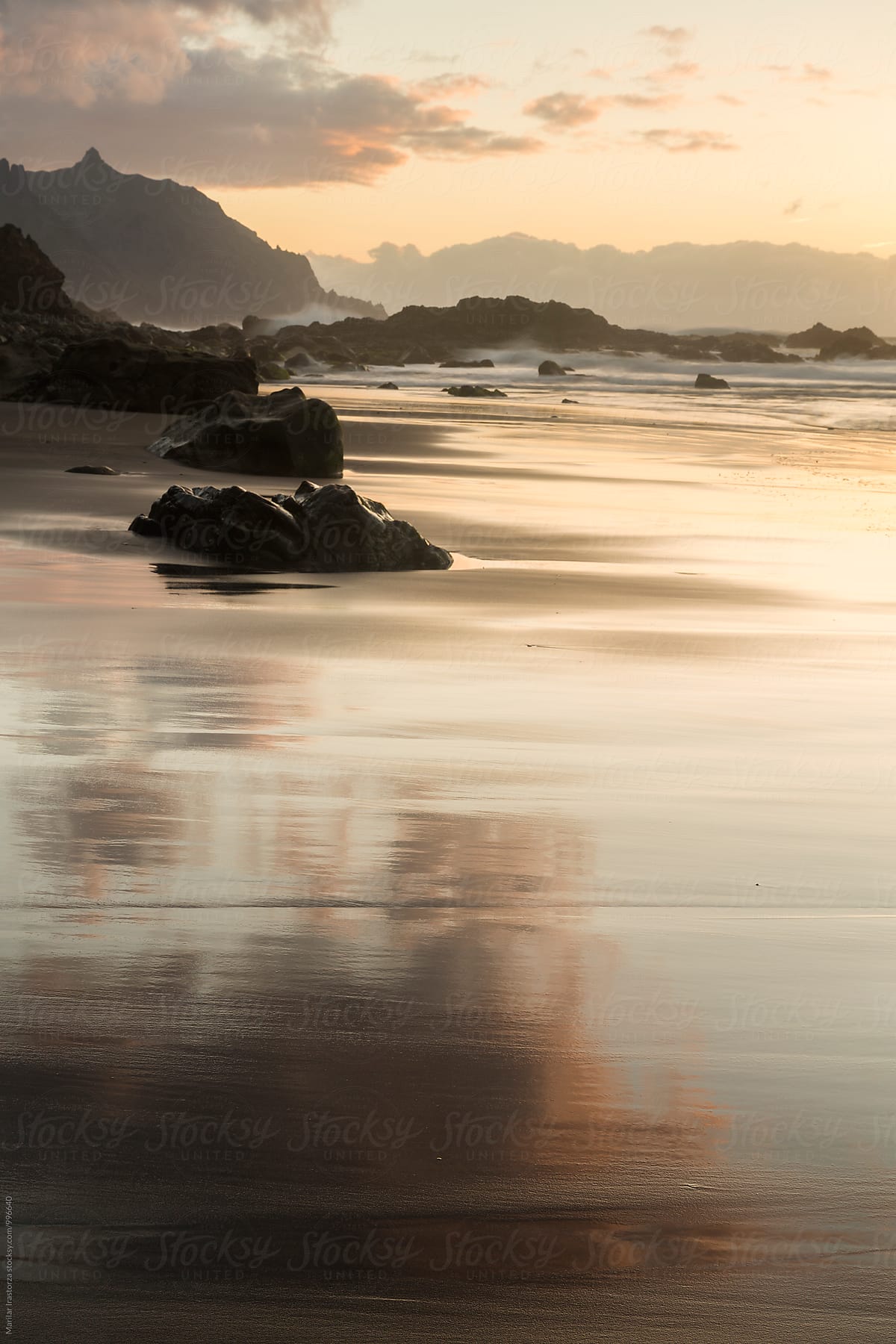"Hazy Sunset And Low Tide On A Beach Of Black Sand" by Stocksy ...