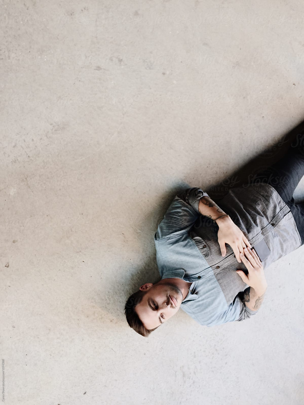 "Man Laying Upside Down" by Stocksy Contributor "Carey Shaw" - Stocksy