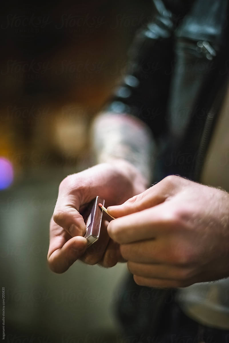 "Man Holding A Match" by Stocksy Contributor "Koganami Studio" - Stocksy