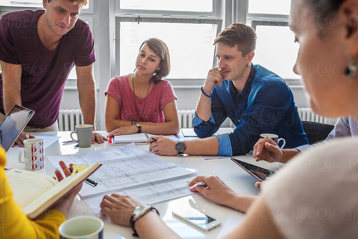 "Colleagues Discussing The Project" by Stocksy Contributor "Jelena ...