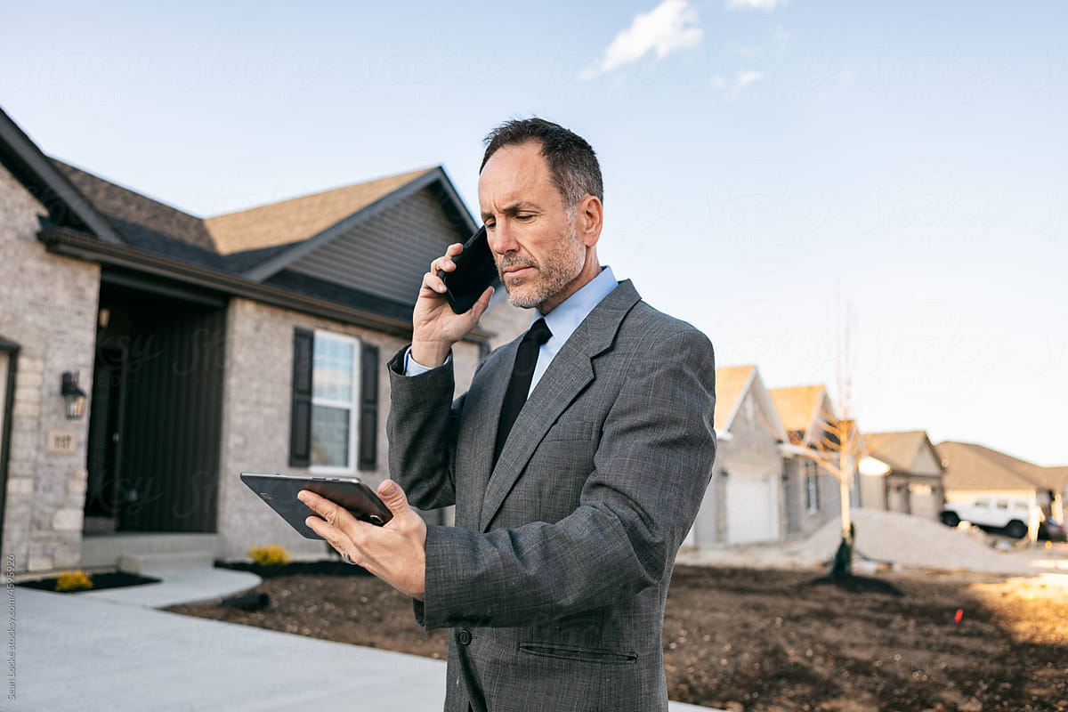 "Real Estate Agent In Phone Discussion" by Stocksy Contributor "Sean ...