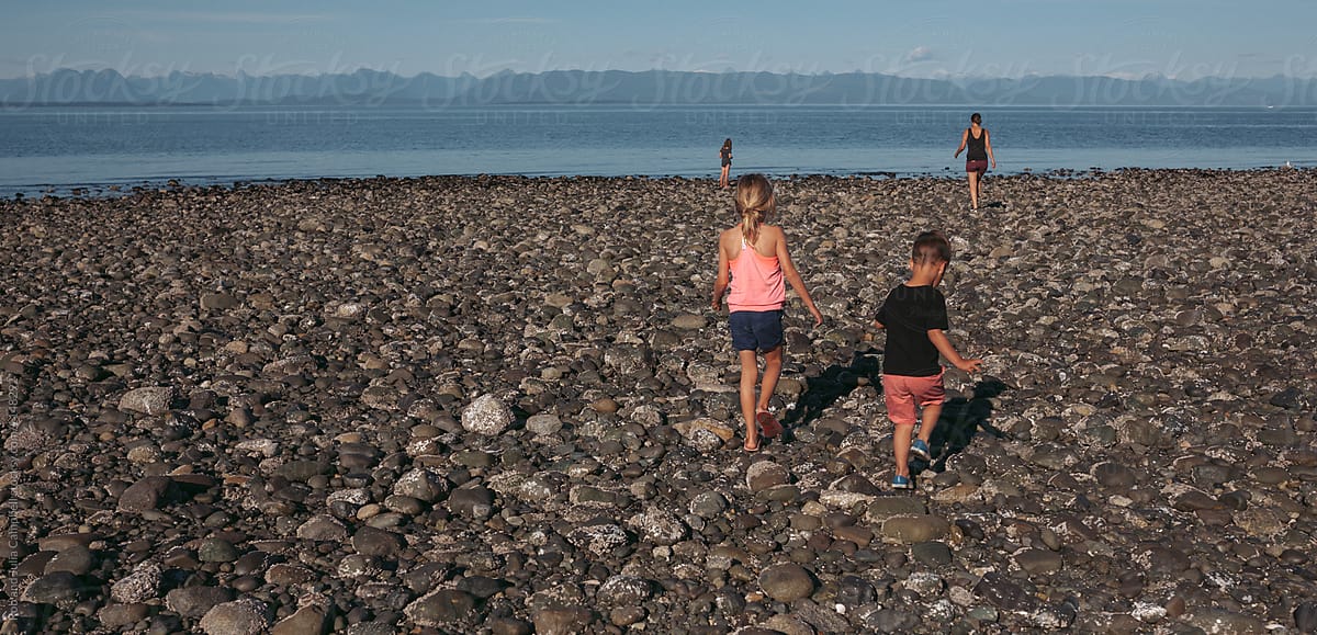 "Family Walking On Beach In Late Afternoon Sunshine" by Stocksy ...