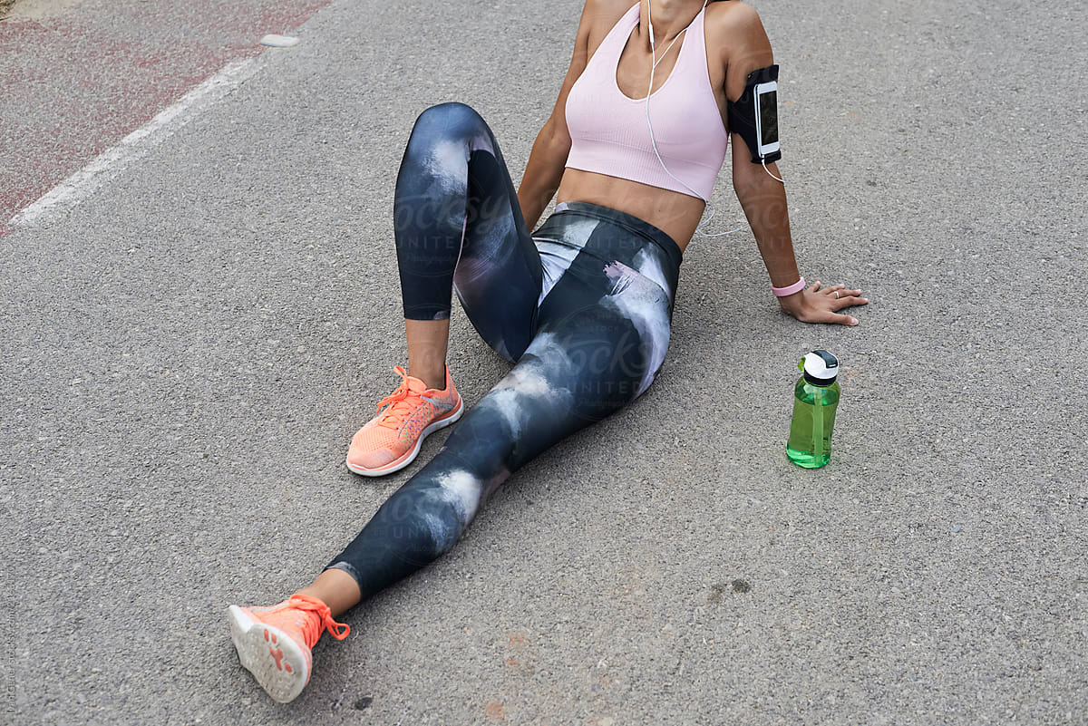 "Faceless Runner Resting On The Ground" by Stocksy Contributor "Ivan ...