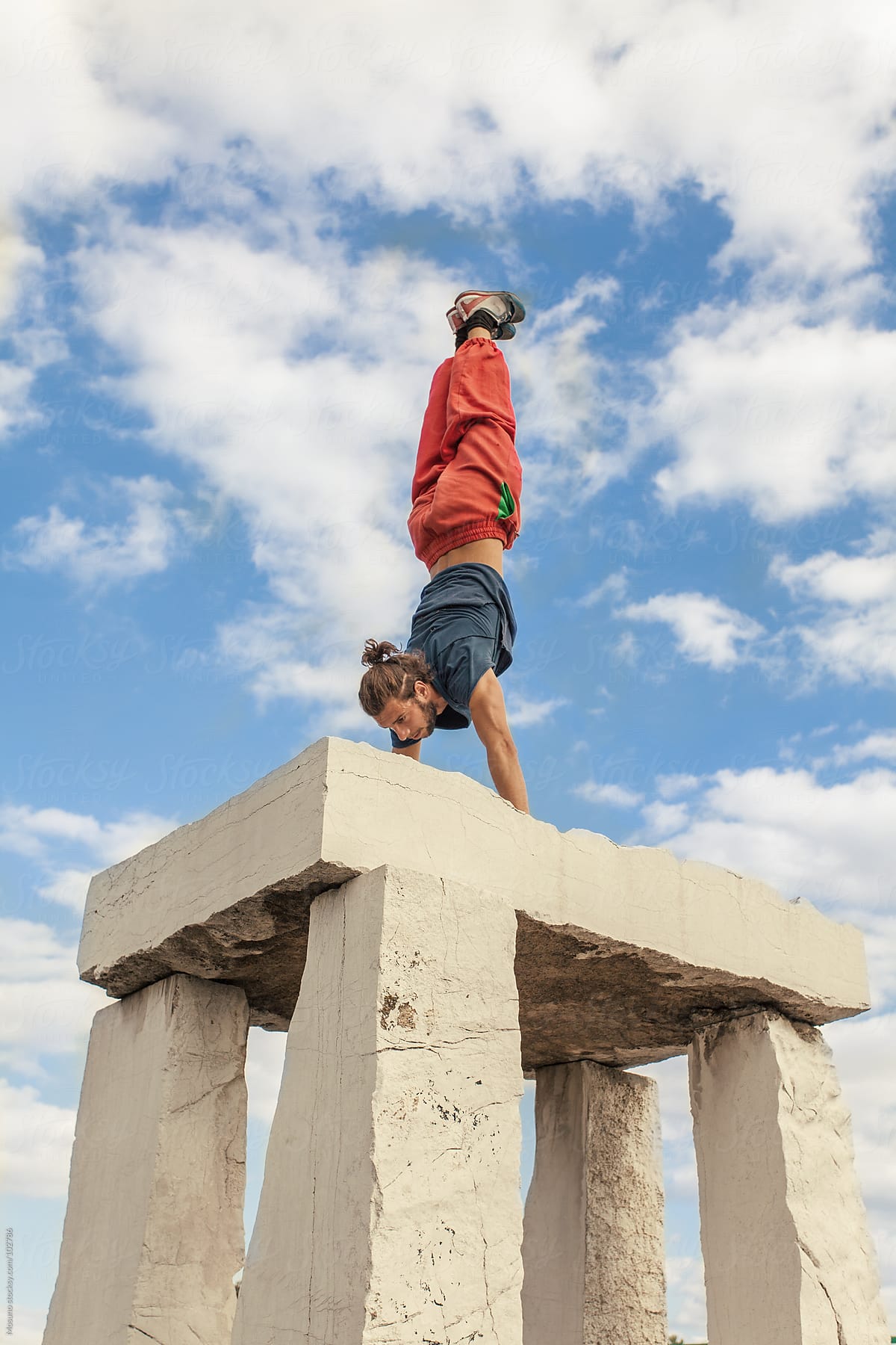 "Man Doing Handstand" by Stocksy Contributor "Mosuno" - Stocksy