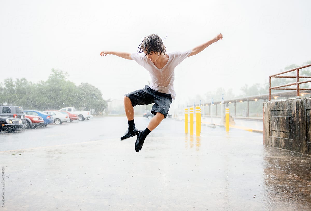 "Boy Dances In The Rain" by Stocksy Contributor "Cara Dolan" - Stocksy