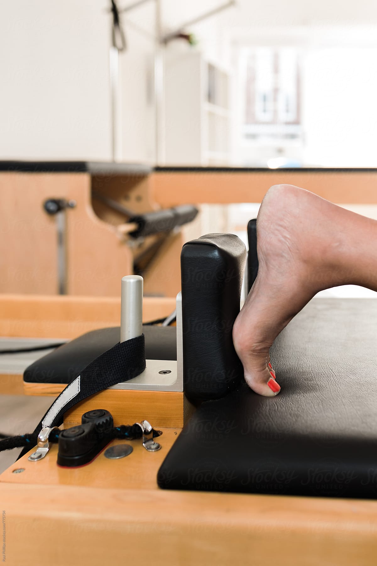 "Woman's Foot Pressed Against Stop On A Reformer. Pilates Exercise." by ...
